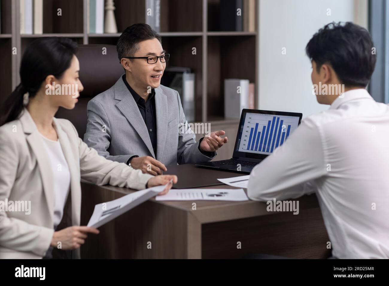 Confident Chinese business people having a meeting Stock Photo - Alamy