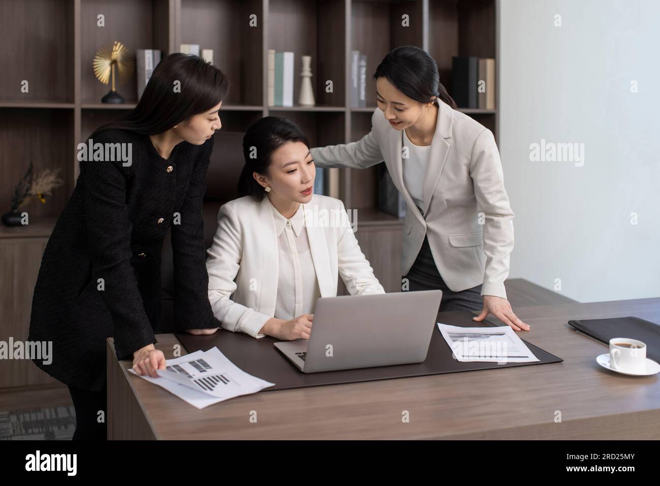 Confident Chinese business people having a meeting Stock Photo - Alamy