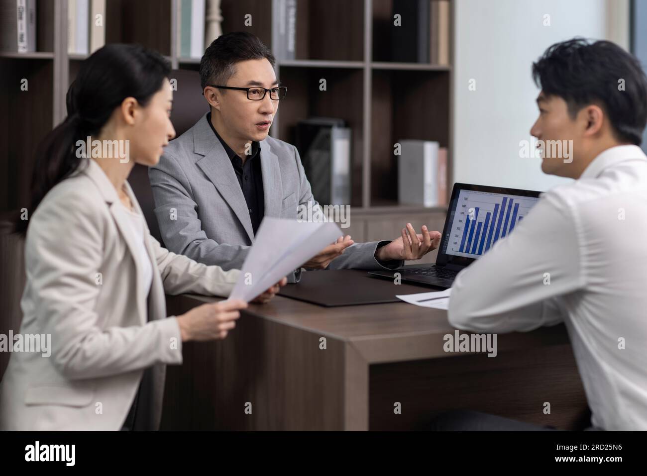 Confident Chinese business people having a meeting Stock Photo - Alamy