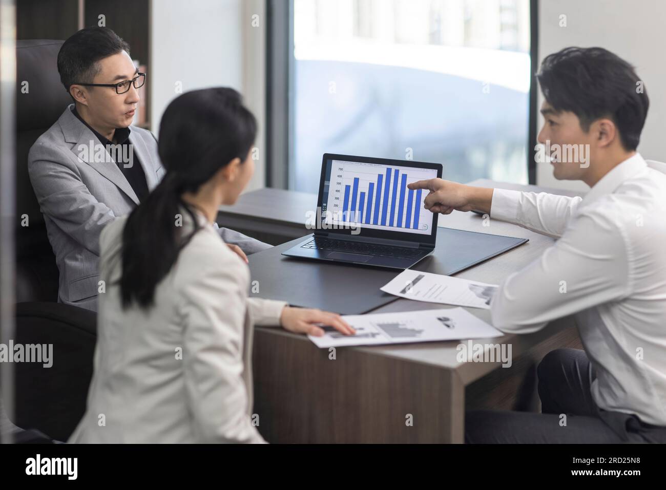 Confident Chinese business people having a meeting Stock Photo - Alamy