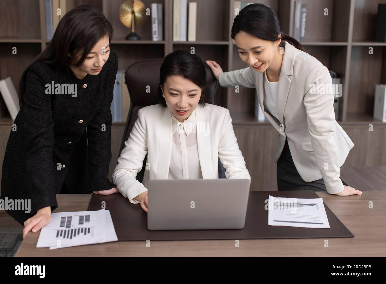 Confident Chinese business people talking in office Stock Photo - Alamy