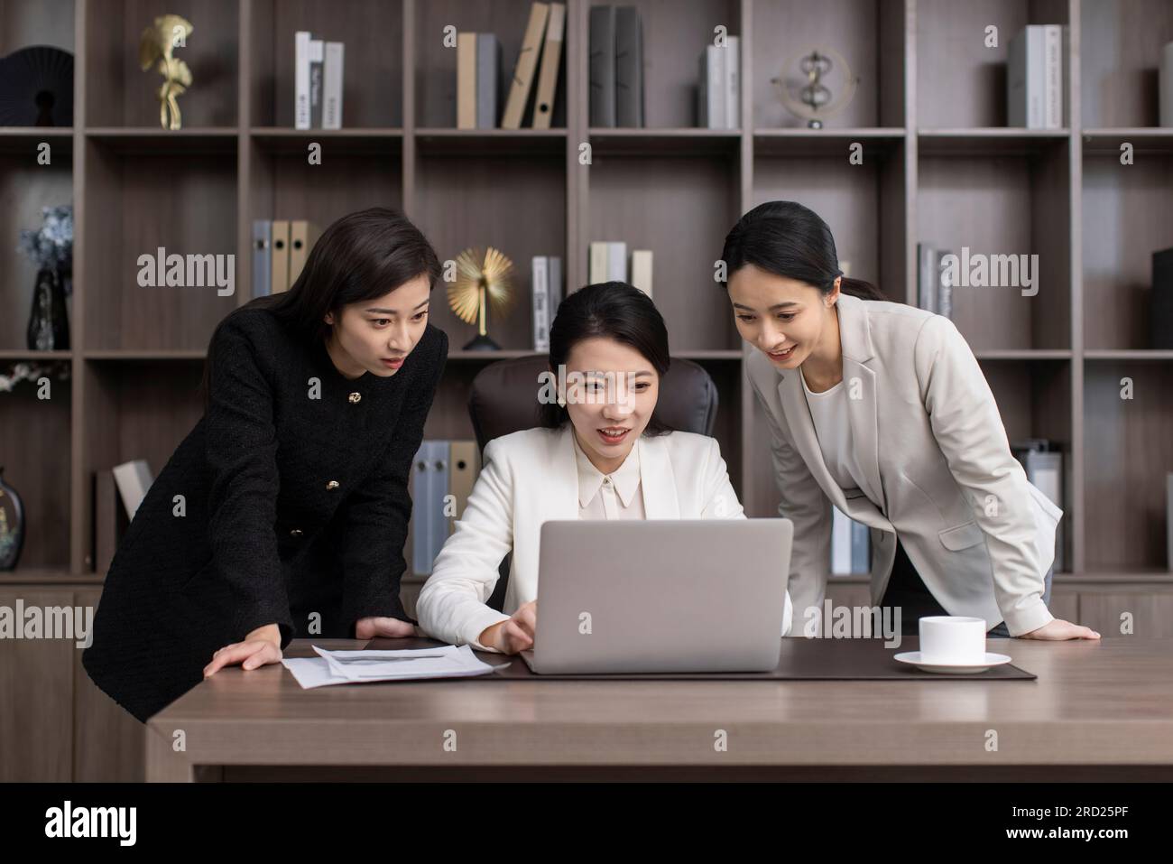 Confident Chinese business people talking in office Stock Photo - Alamy