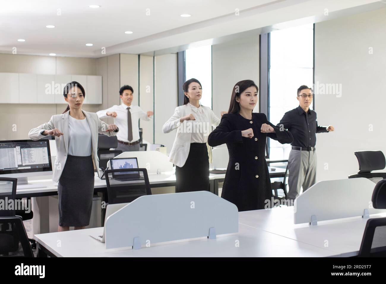 Chinese business people exercising in office Stock Photo - Alamy