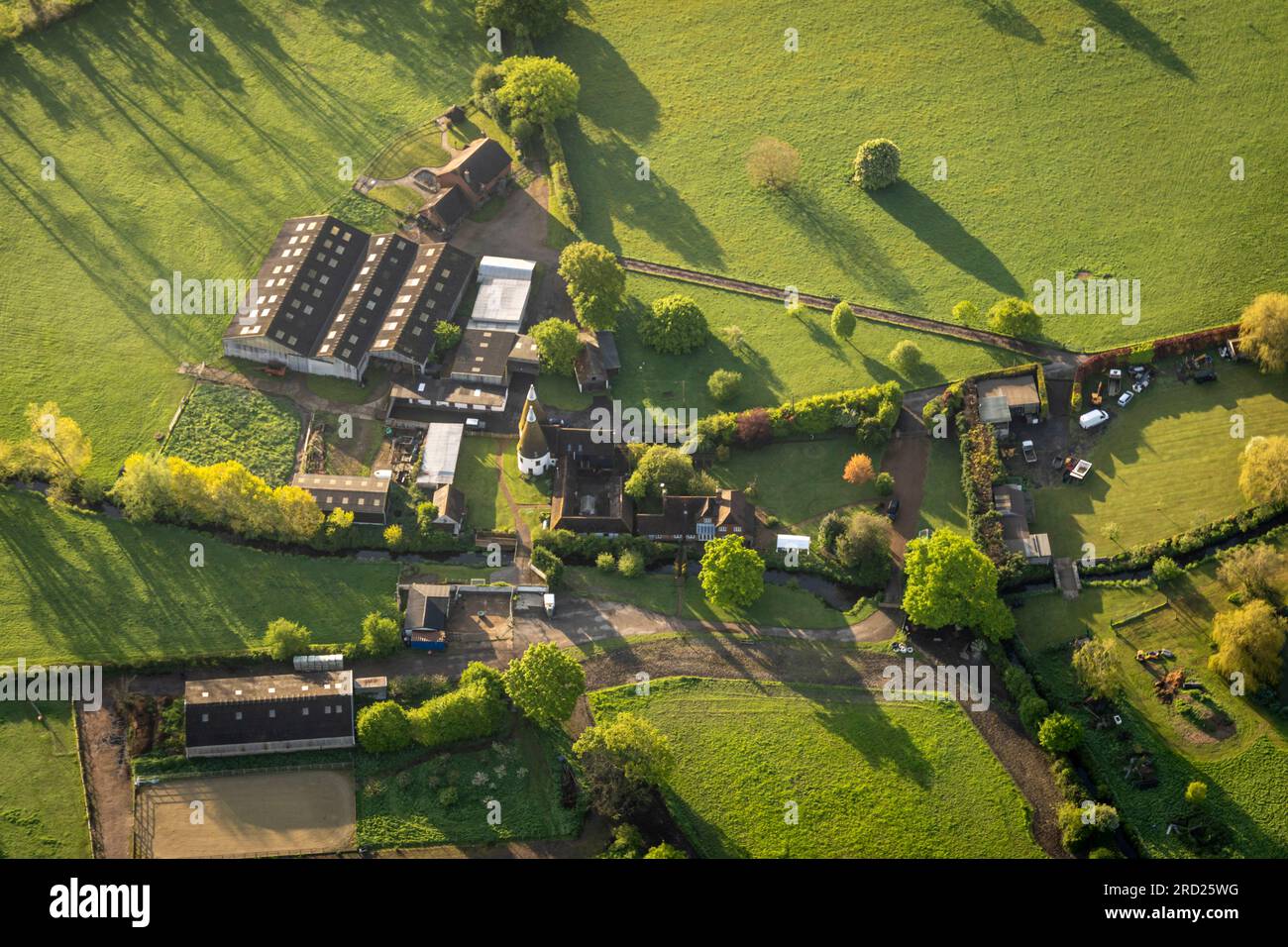 Aerial view of a farm with oast houses in the countryside in Kent, UK ...