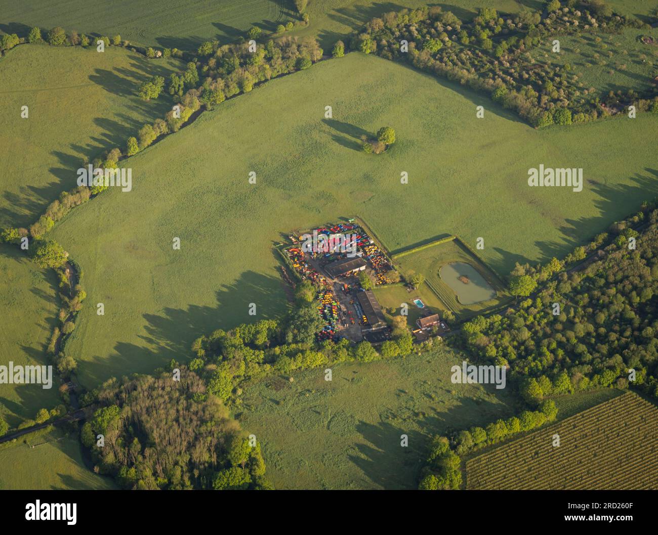 Aerial view of a farm and surrounding fields in the countryside in Kent ...