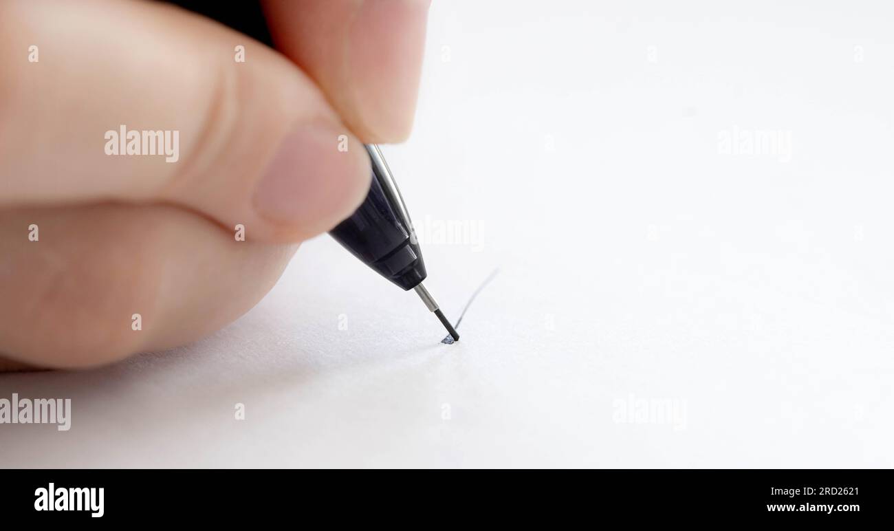 Person hand holding pen and writing on white paper closeup. Fingers ...