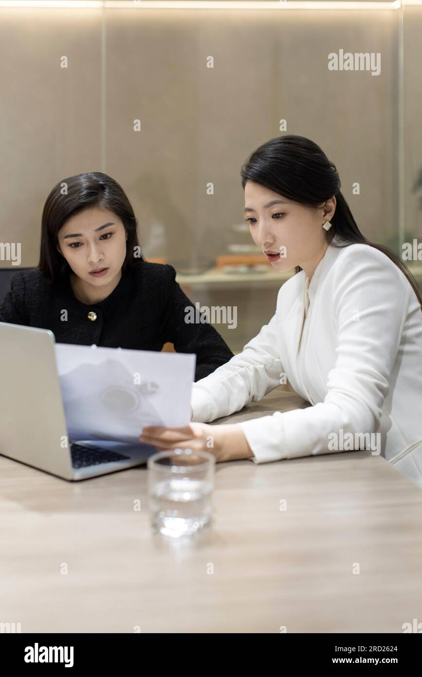 Confident Chinese businesswomen having a meeting Stock Photo - Alamy