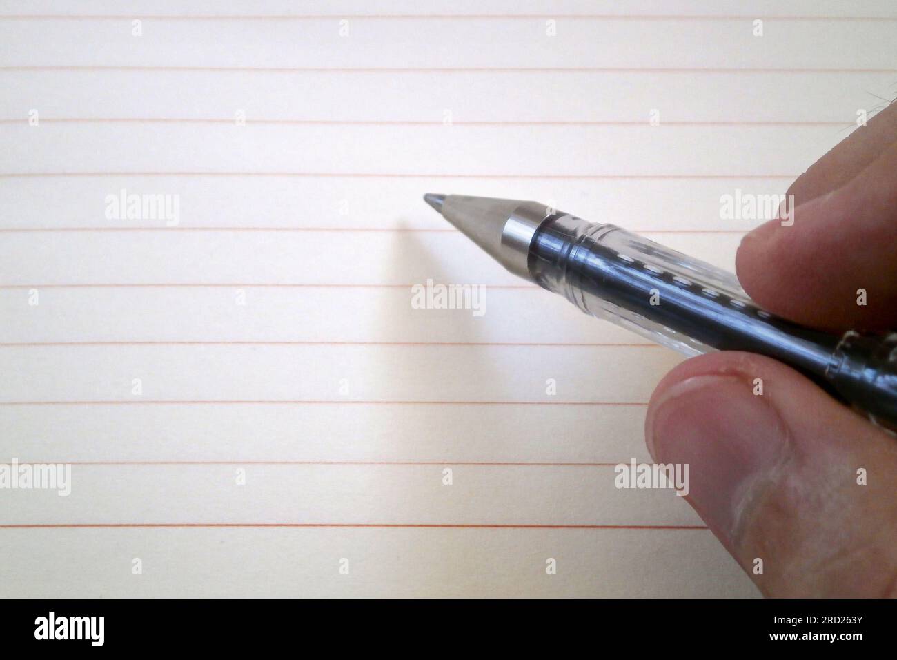 Pen hold by the fingers of someone ready to write down something on a ...