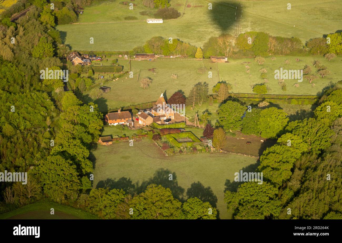 Aerial view of a farm and surrounding fields in the countryside in Kent ...