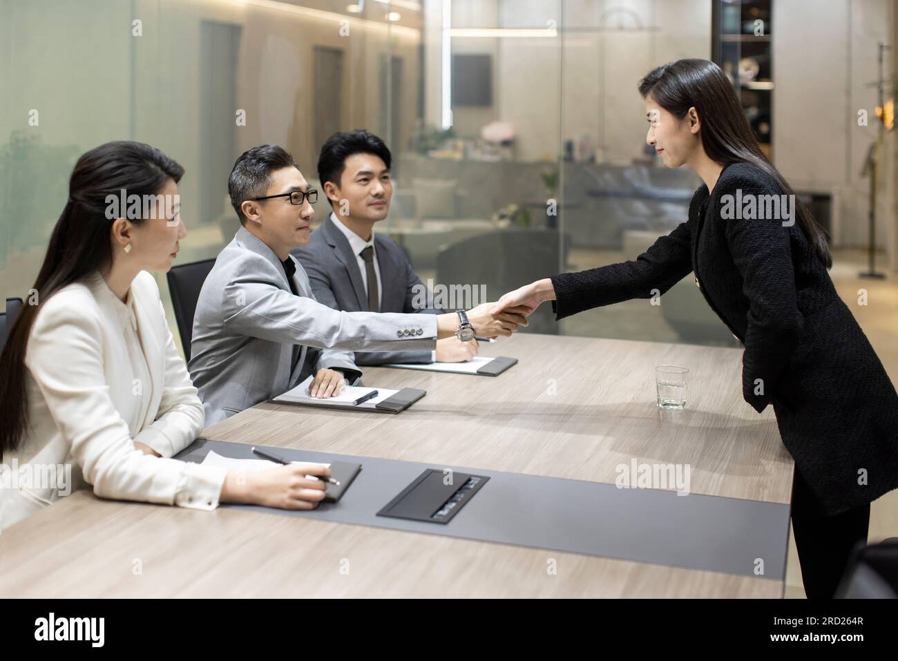 Confident Chinese businesswoman attending job interview Stock Photo - Alamy