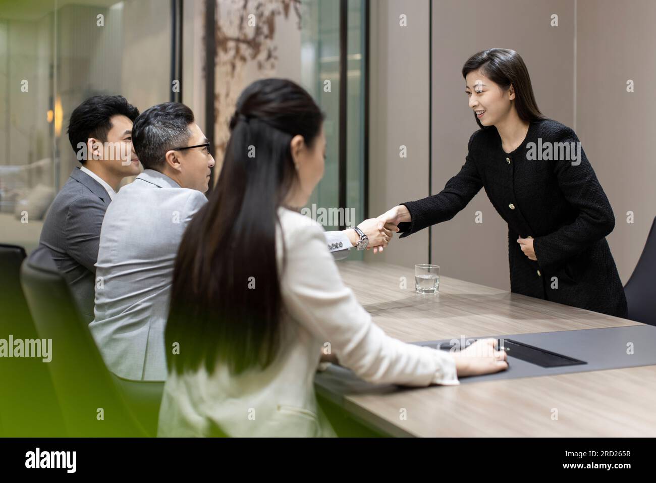 Confident Chinese businesswoman attending job interview Stock Photo - Alamy