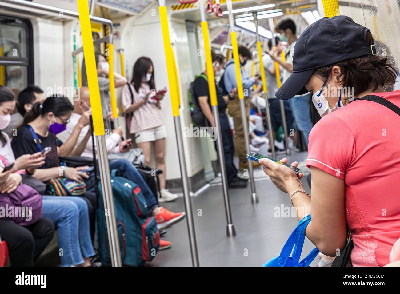 Passengers on MTR rapid transit train, Hong Kong, SAR, China Stock Photo - Alamy