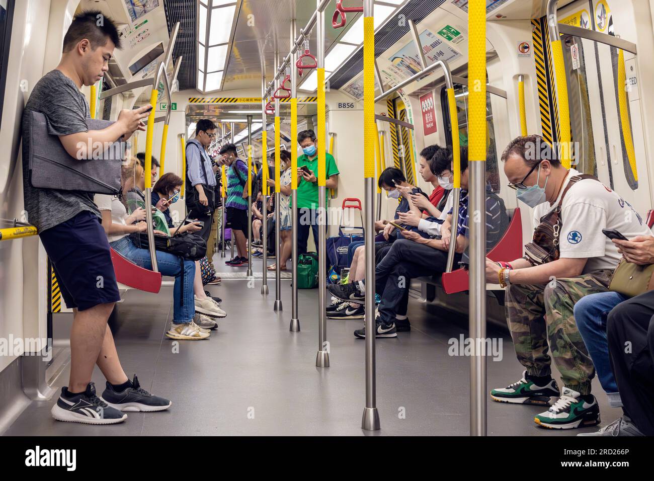 Passengers on MTR rapid transit train, Hong Kong, SAR, China Stock Photo - Alamy