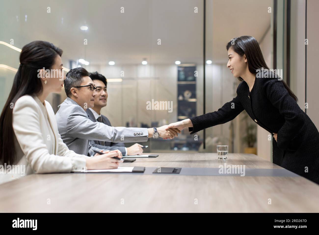 Confident Chinese businesswoman attending job interview Stock Photo - Alamy