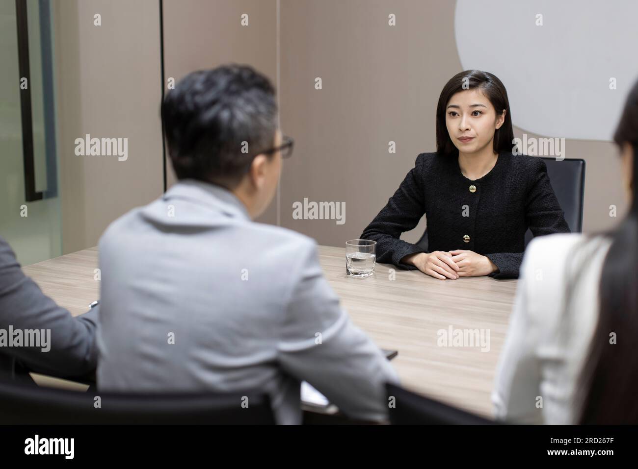 Confident Chinese businesswoman attending job interview Stock Photo - Alamy