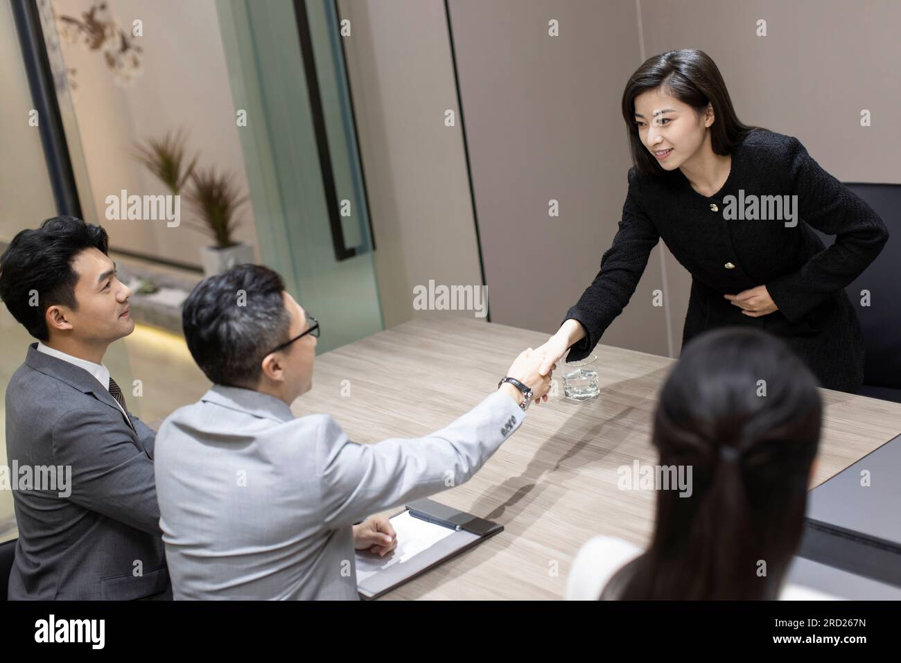 Confident Chinese businesswoman attending job interview Stock Photo - Alamy