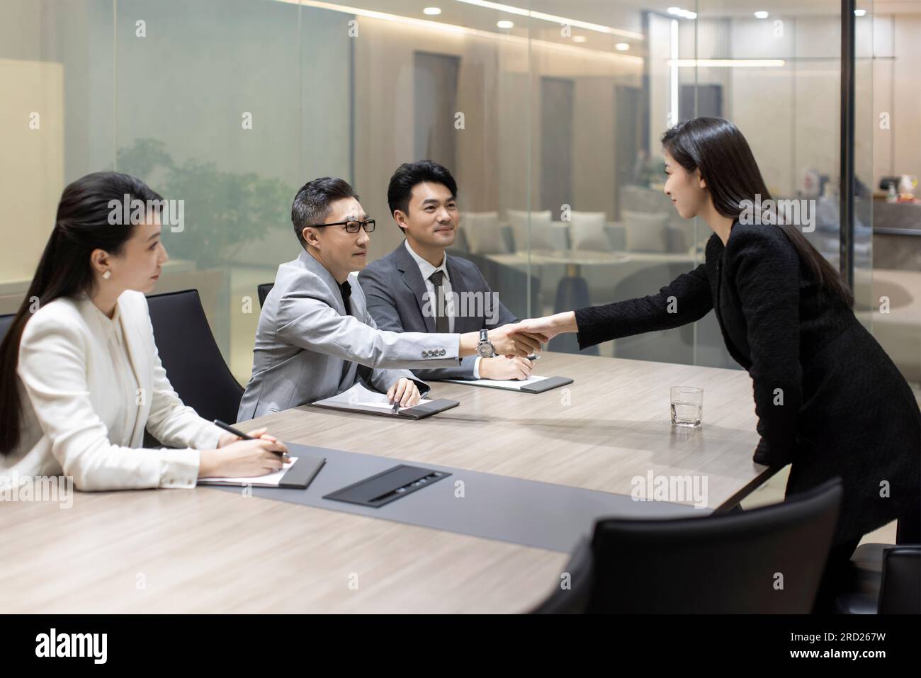Confident Chinese businesswoman attending job interview Stock Photo - Alamy