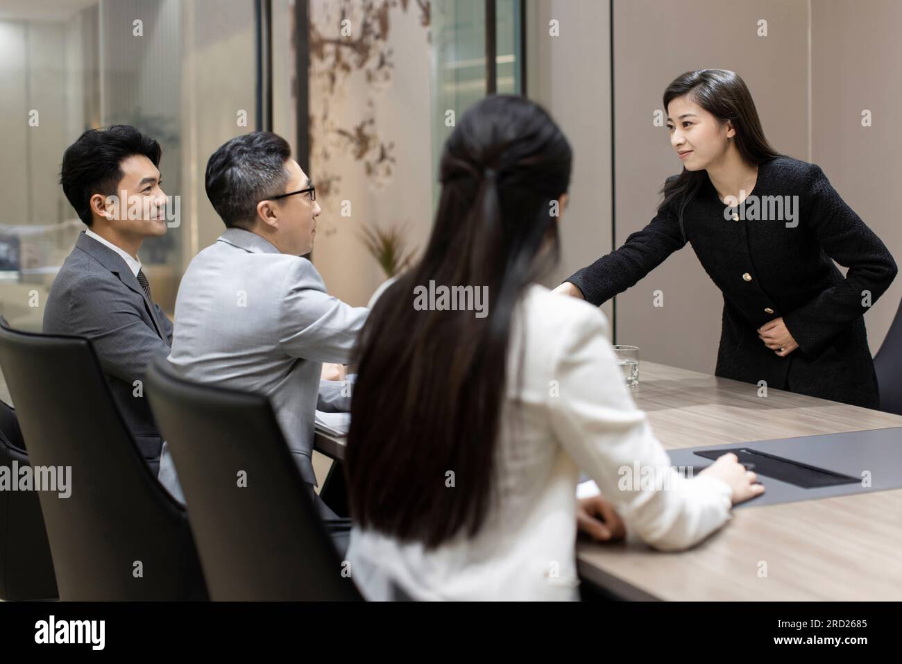 Confident Chinese businesswoman attending job interview Stock Photo - Alamy