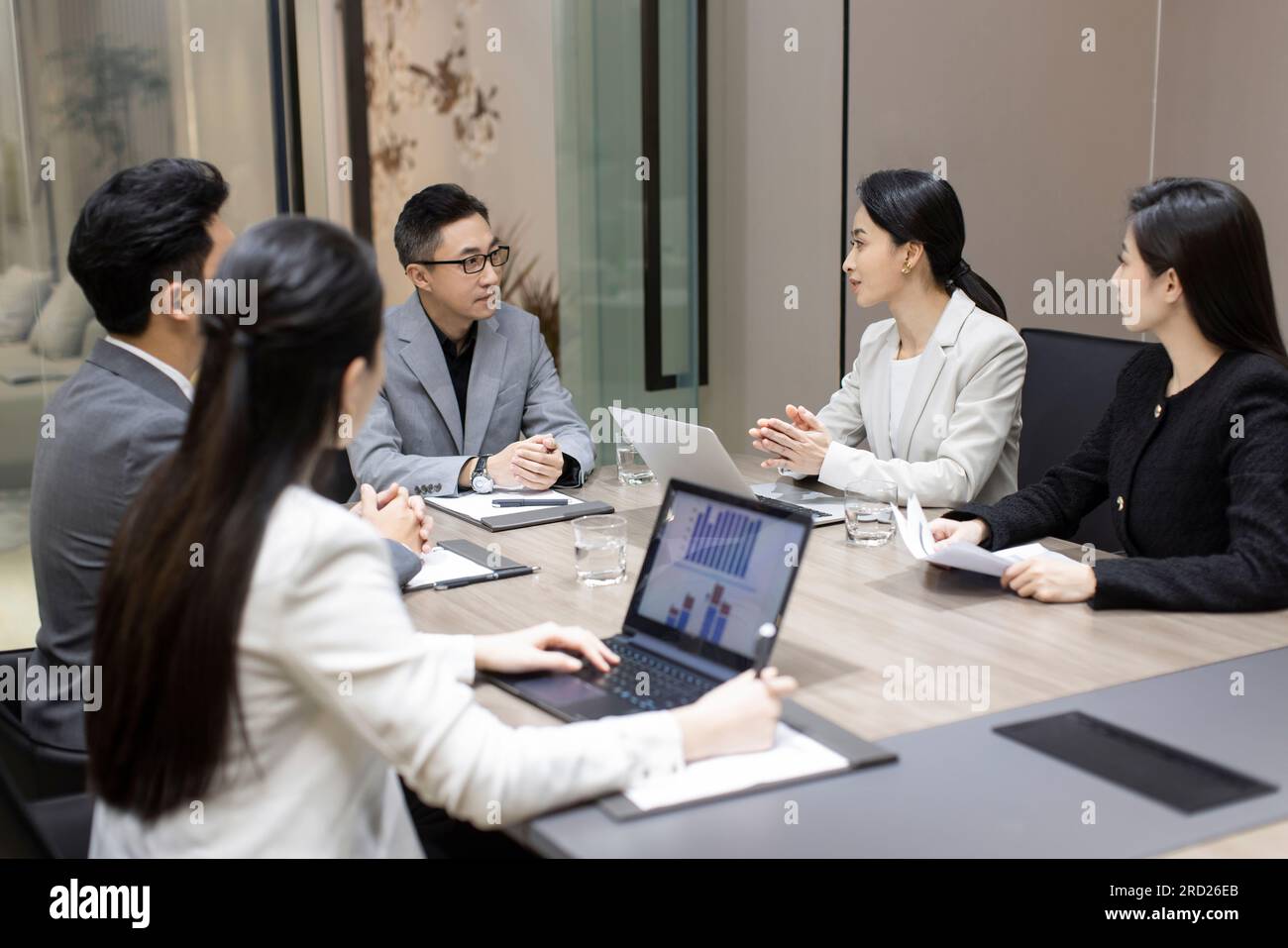 Confident Chinese business people having a meeting Stock Photo - Alamy