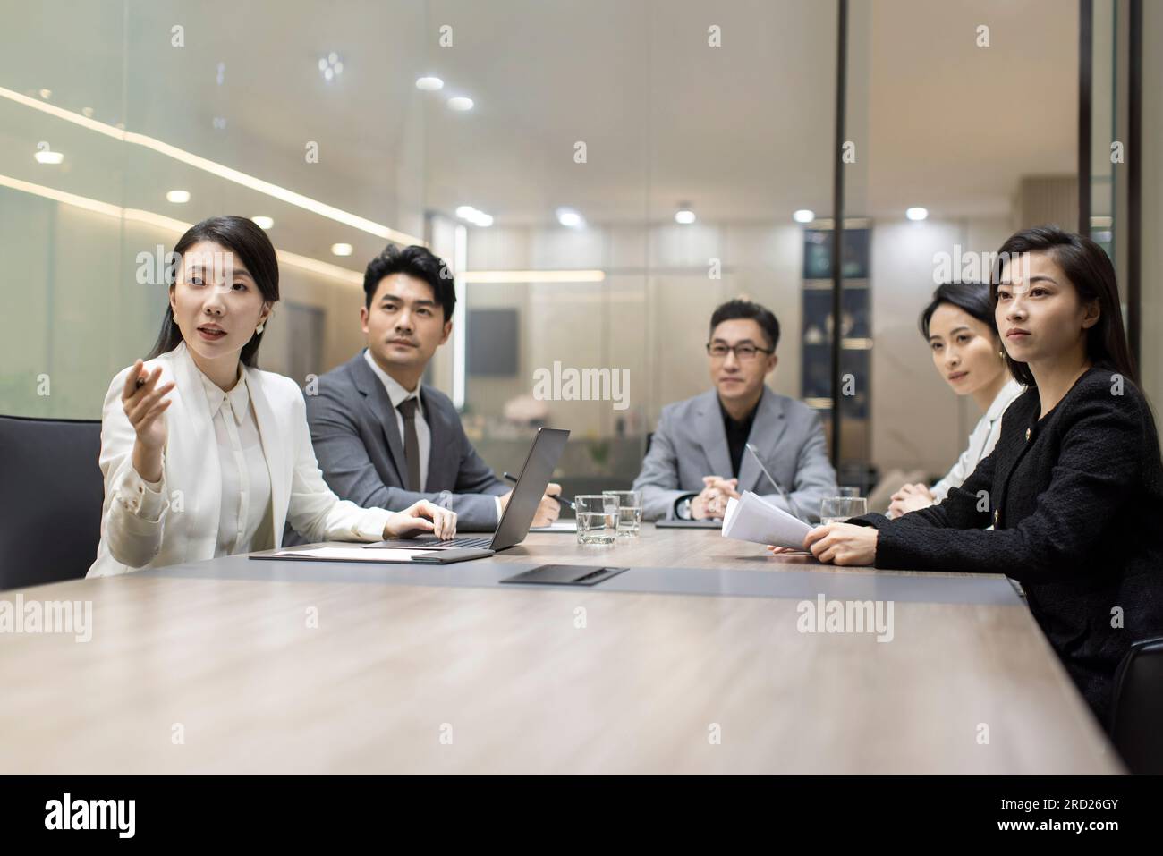 Confident Chinese business people having a meeting Stock Photo - Alamy