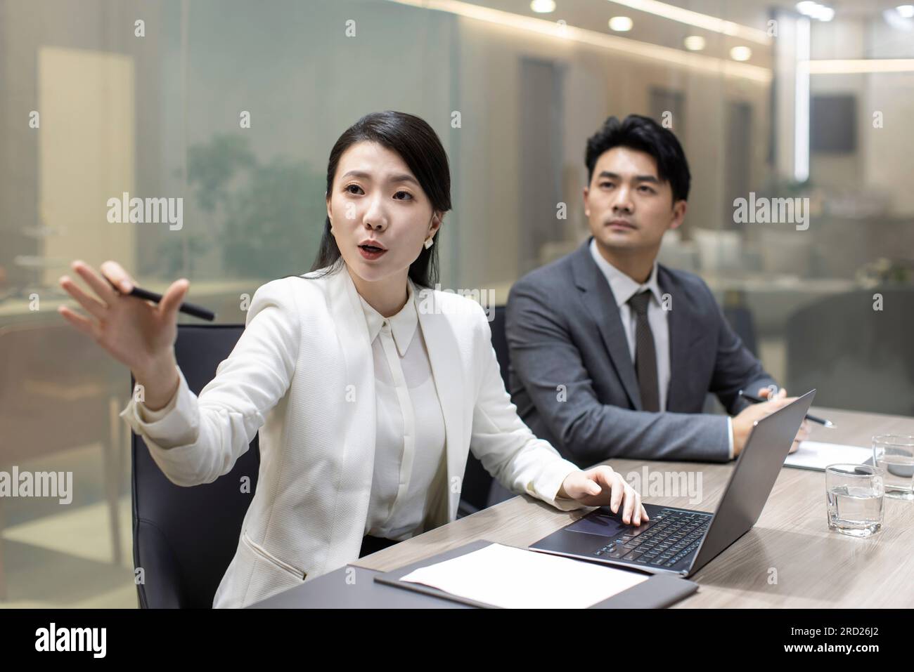 Confident Chinese business people having a meeting Stock Photo - Alamy