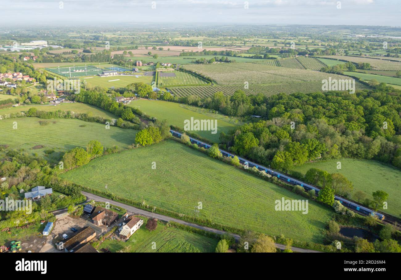 Aerial view of a train on a railway line in the village of Marden in ...