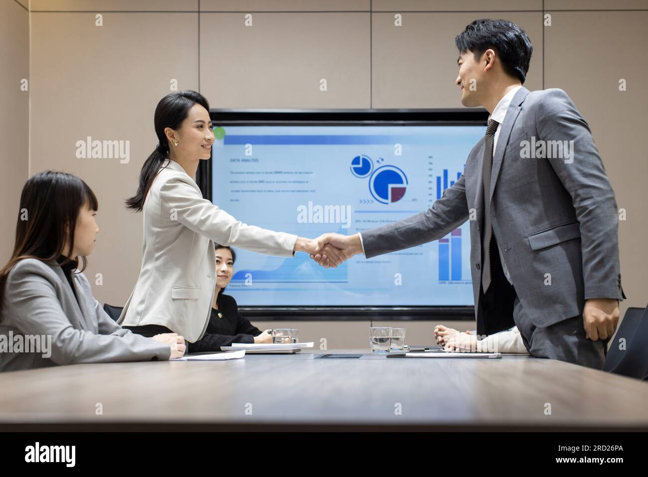 Successful Chinese business people shaking hands Stock Photo - Alamy