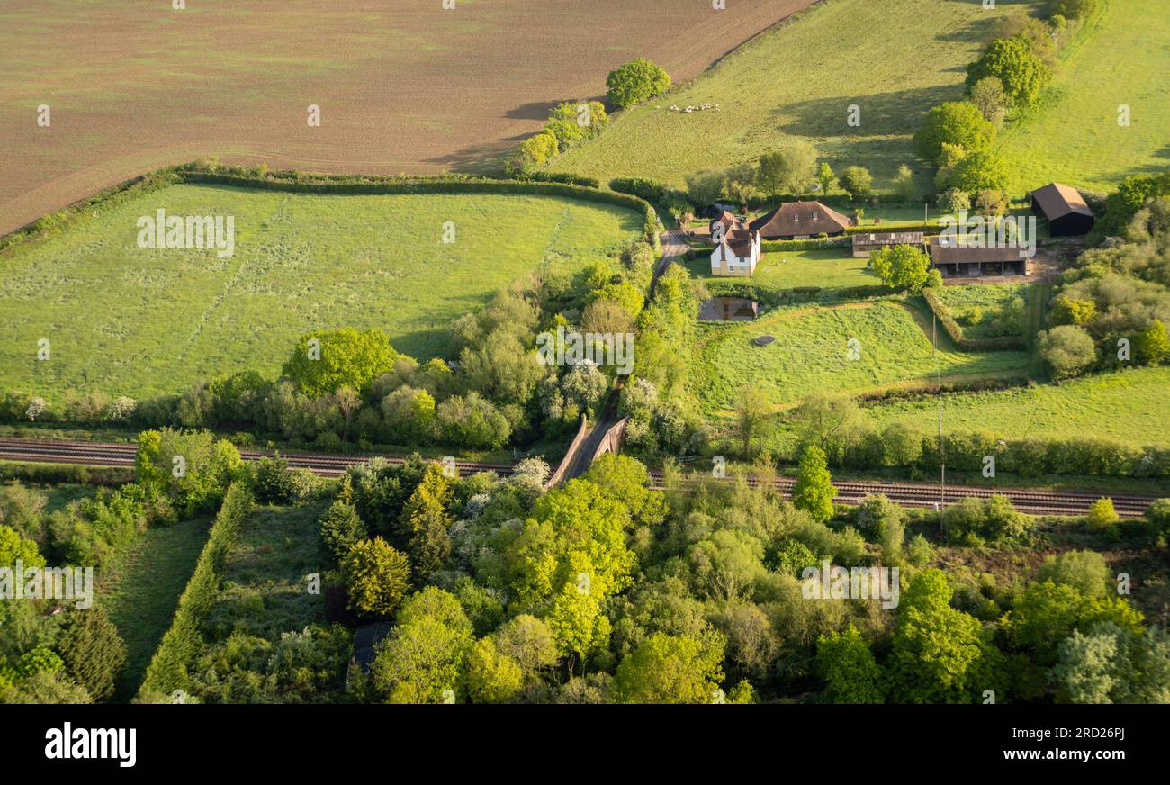 Aerial view of a farm and surrounding fields in the countryside in Kent ...
