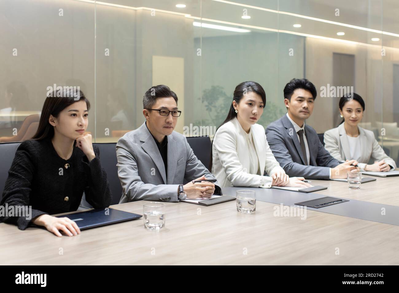 Confident Chinese business people having a meeting Stock Photo - Alamy