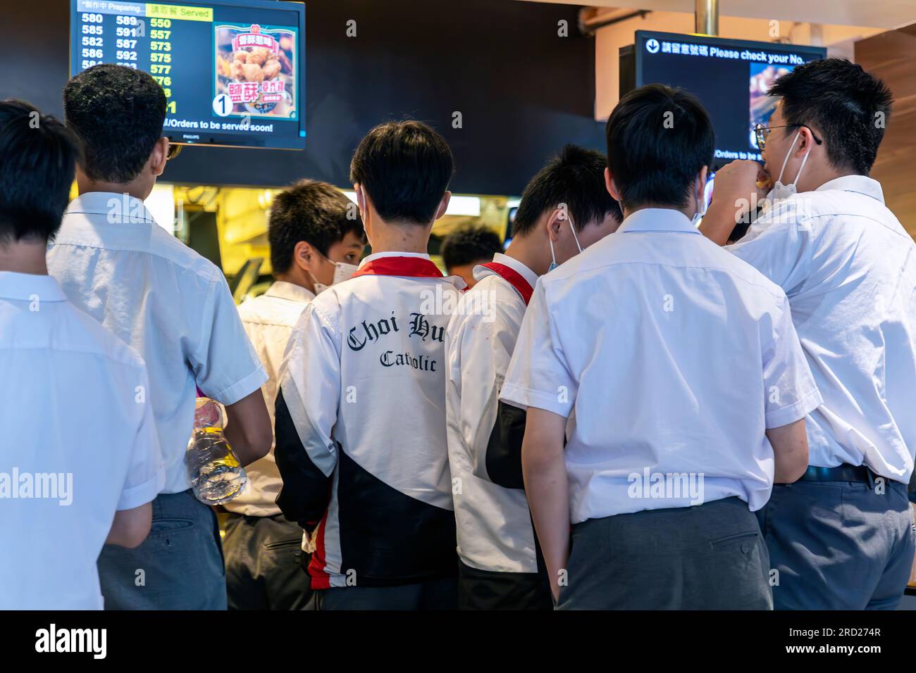 School children ordering at fast food restaurant, Choi Hung Estate, Kowloon, Hong Kong, SAR ...