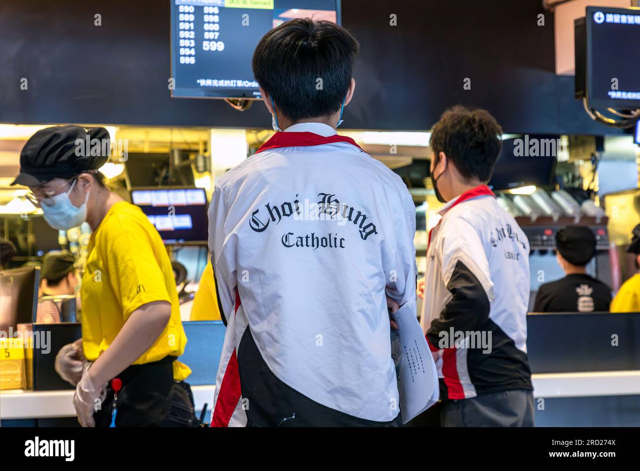 School children ordering at fast food restaurant, Choi Hung Estate, Kowloon, Hong Kong, SAR ...