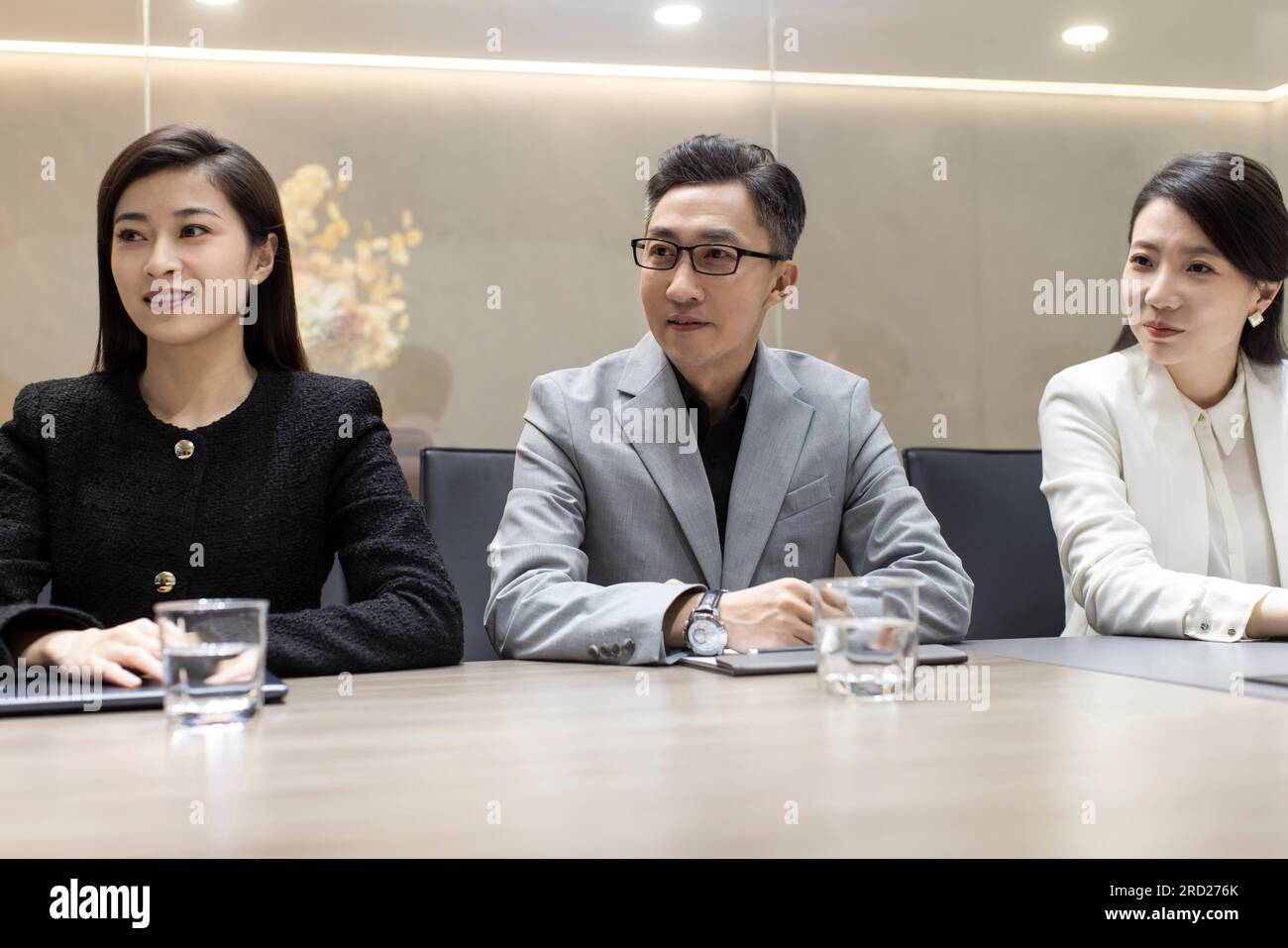 Confident Chinese business people having a meeting Stock Photo - Alamy