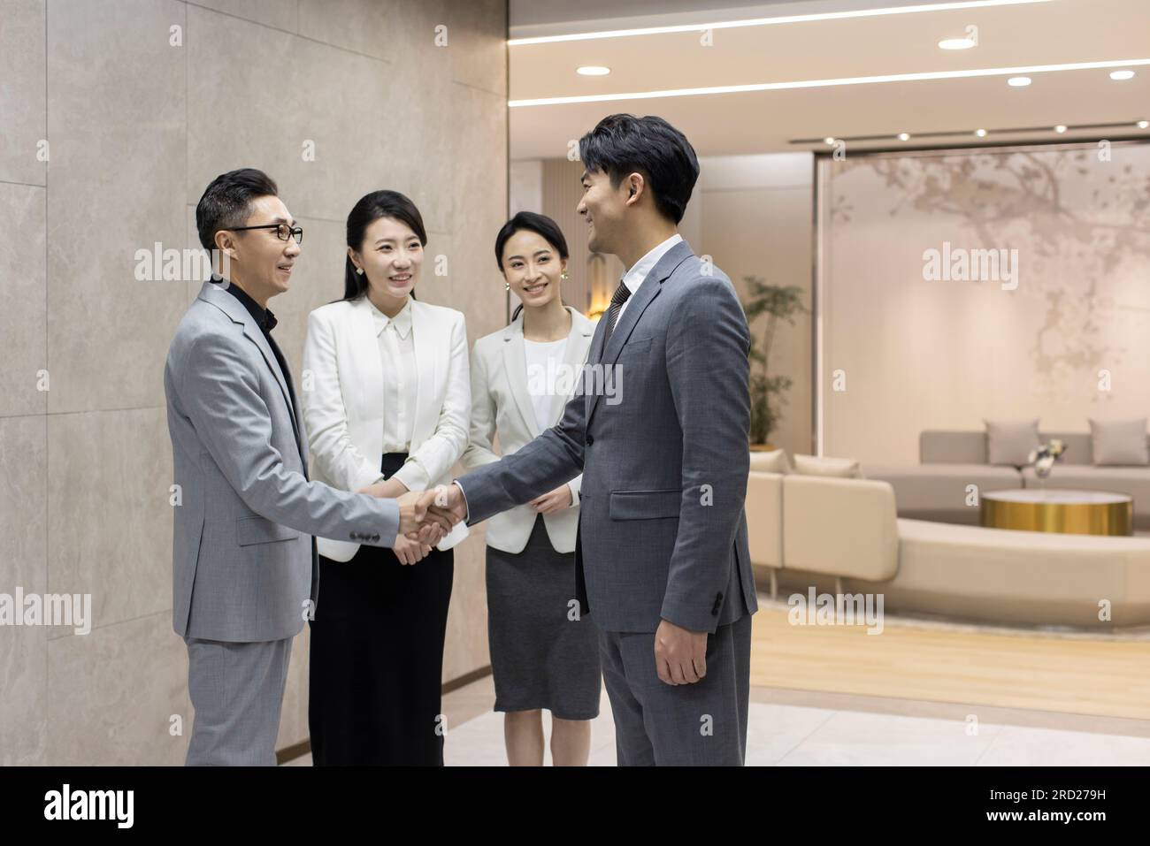 Successful Chinese business people shaking hands Stock Photo - Alamy