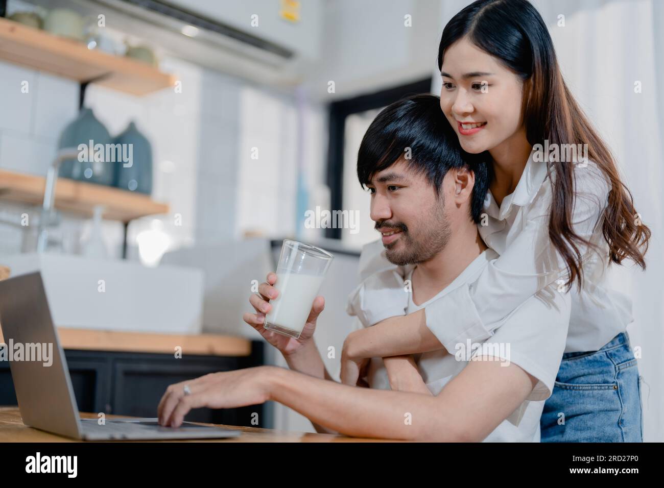 Happy young loving family couple looking at laptop computer screen ...