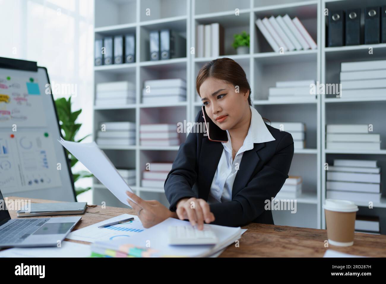 Busy businesswoman wearing a suit busy with work workaholic while ...