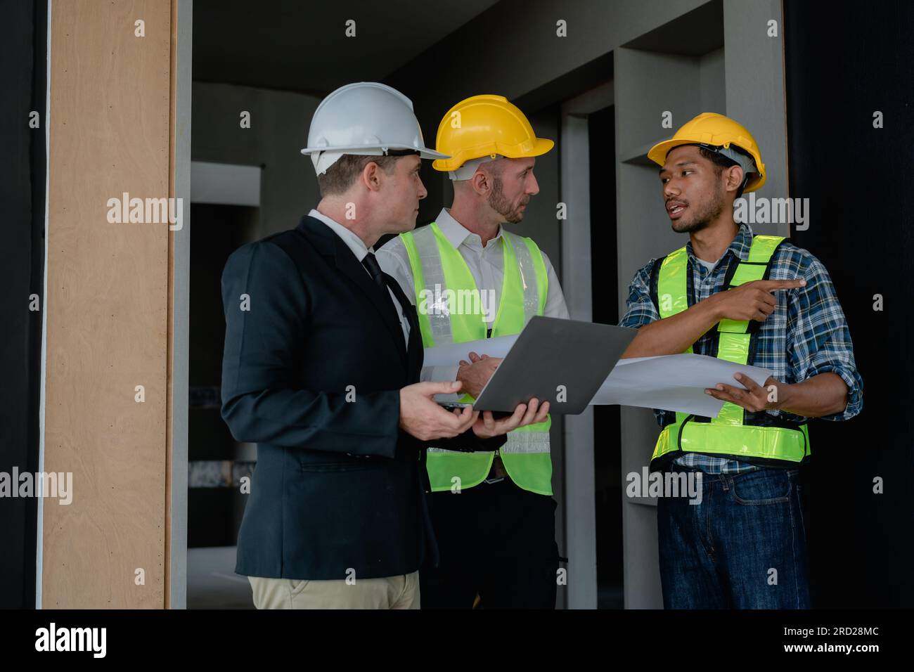 multi ethnic engineer brainstorming and measuring for cost estimating ...