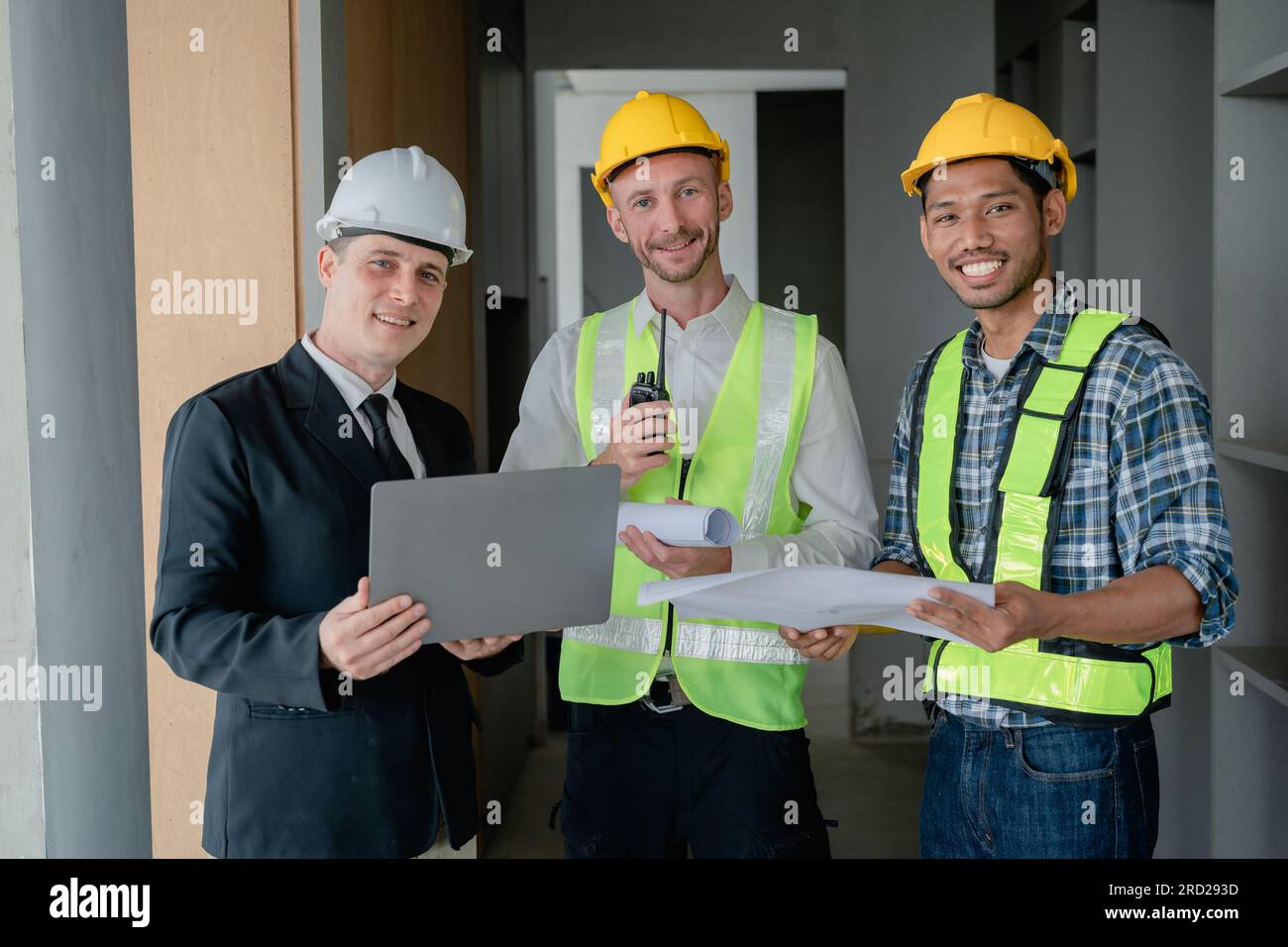 multi ethnic engineer brainstorming and measuring for cost estimating ...