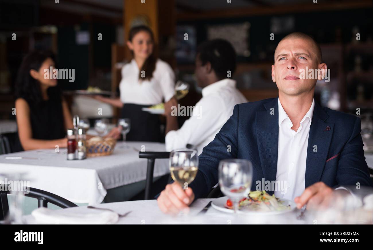 Thoughtful businessman resting and having dinner in restaurant Stock ...