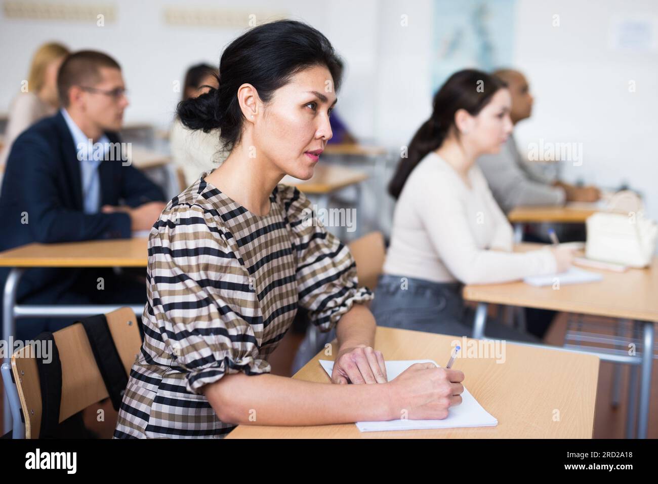 Focused japanese woman listening lecture at adult education class Stock ...
