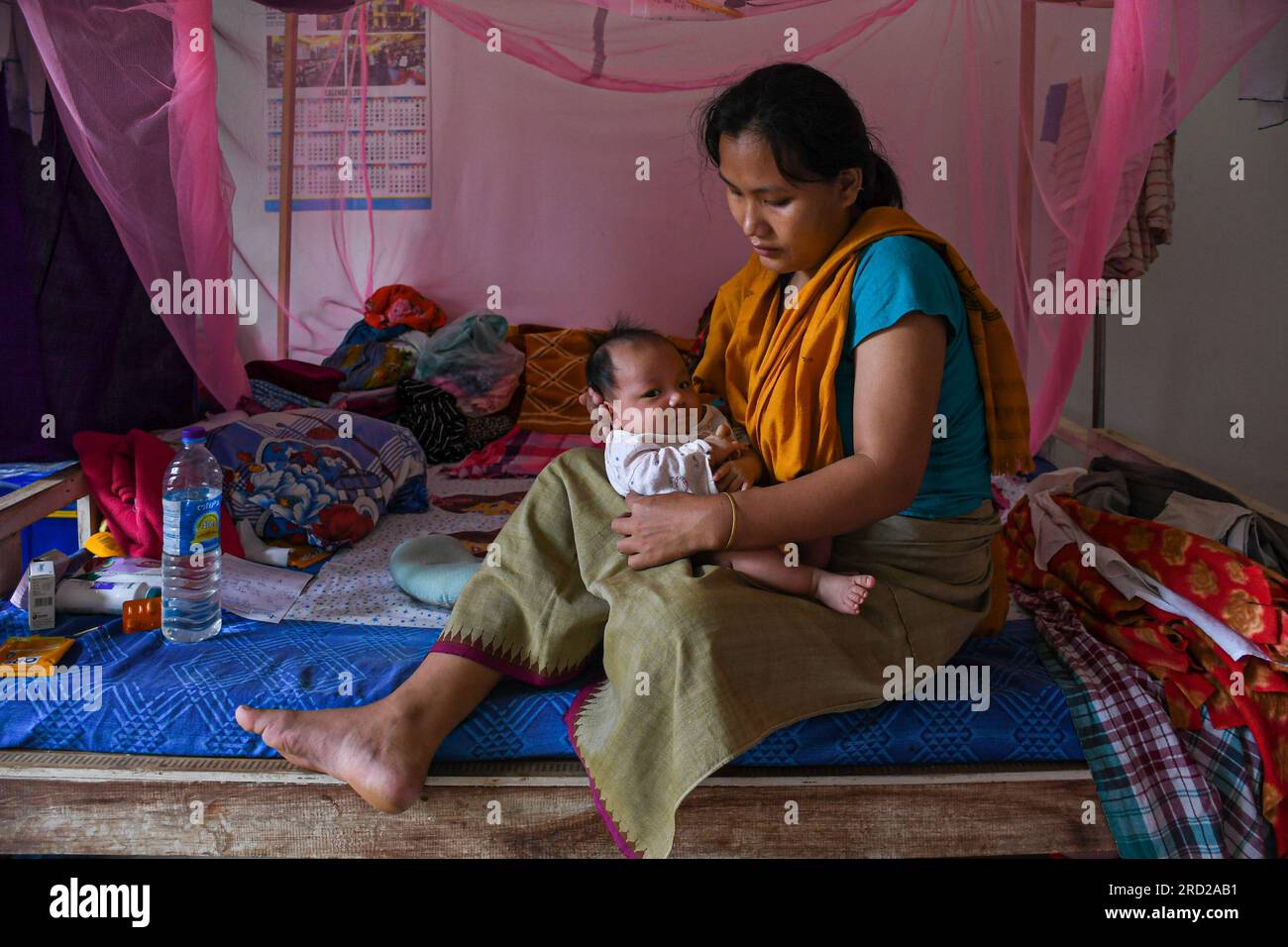 Imphal, India. 16th July, 2023. Radha, 25, poses for a photo with her 1 ...