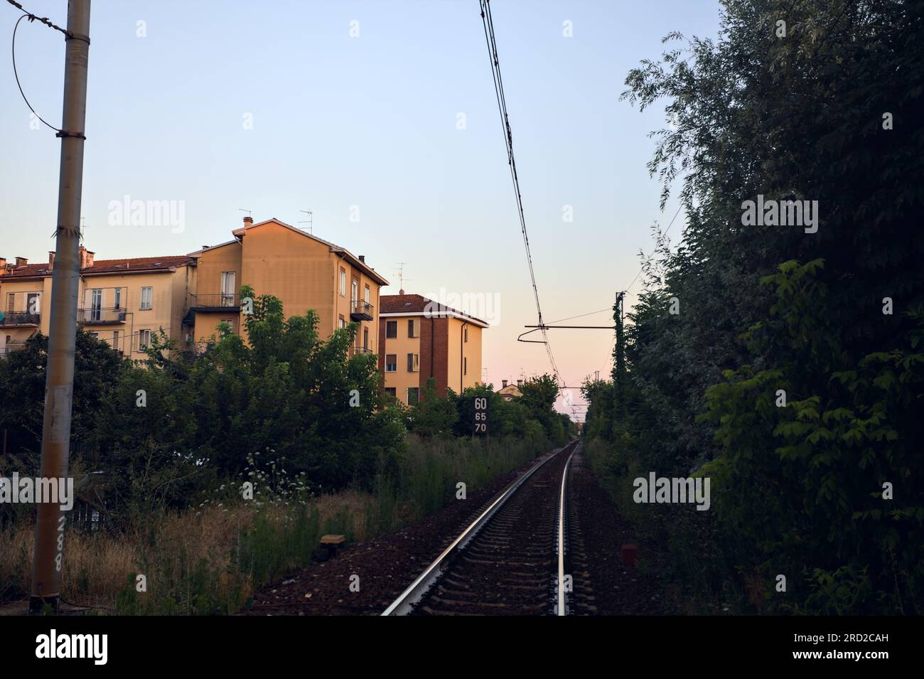 Railroad track in an italian town at sunset Stock Photo - Alamy