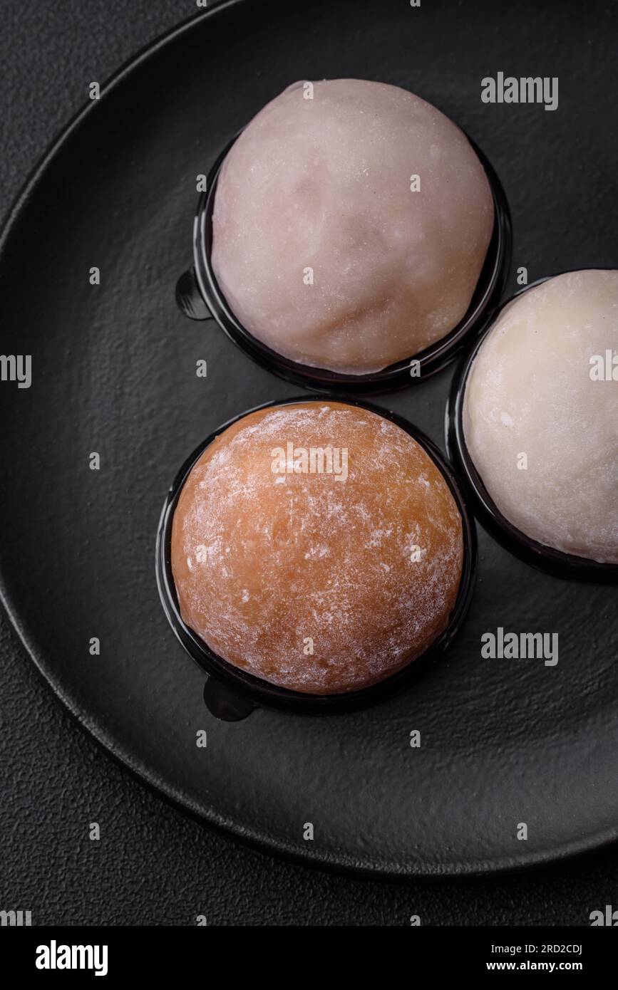 Delicious sweet mochi dessert with toppings on a dark concrete ...