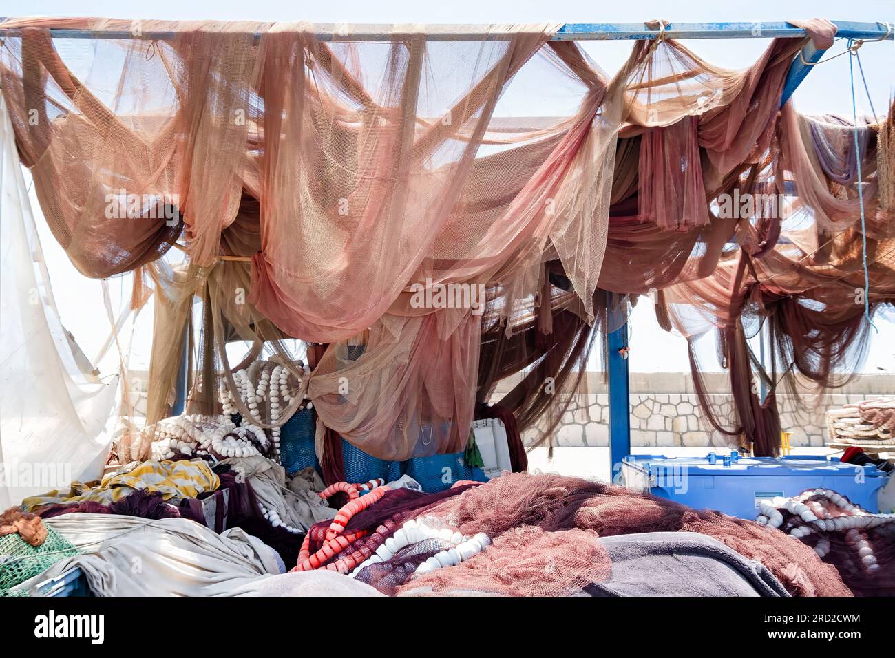 An assortment of trawlerman's fishing nets hung out to dry on the side ...