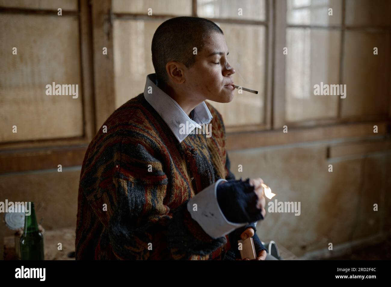 Portrait of young frustrated homeless woman smoking cigarette Stock ...