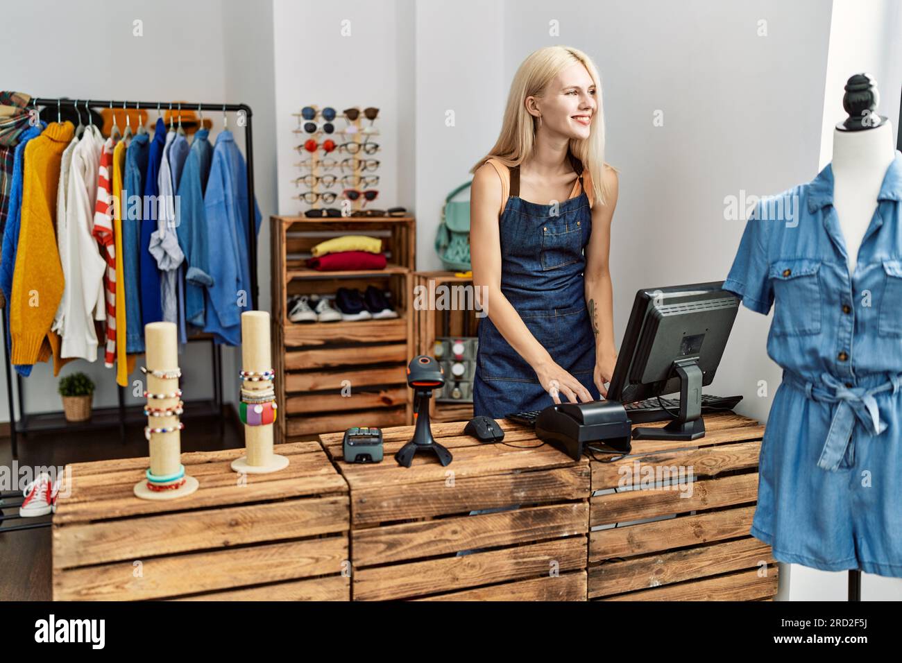 Young blonde woman shop assistant smiling confident using computer at ...