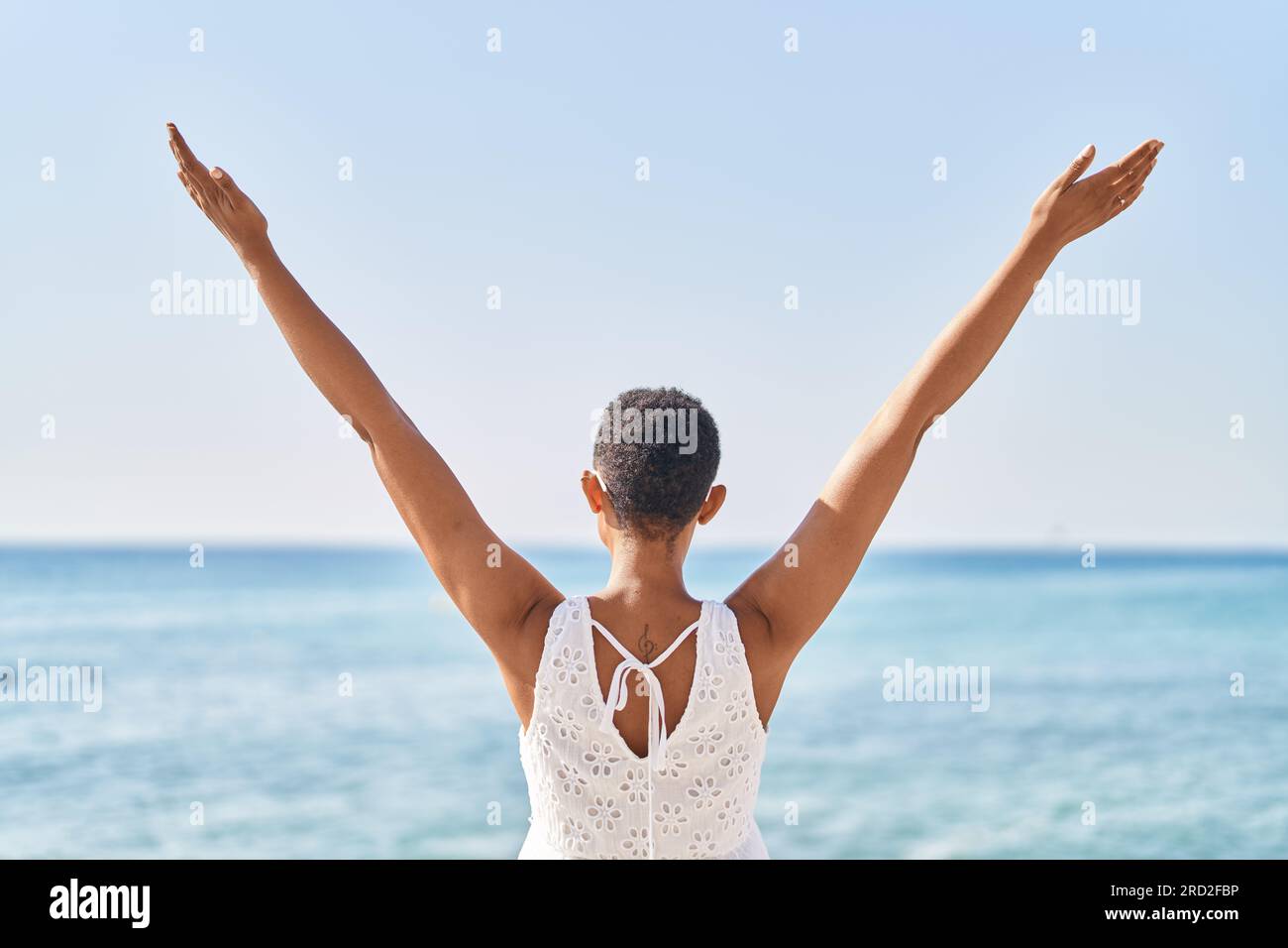 African american woman standing on back view at seaside Stock Photo - Alamy