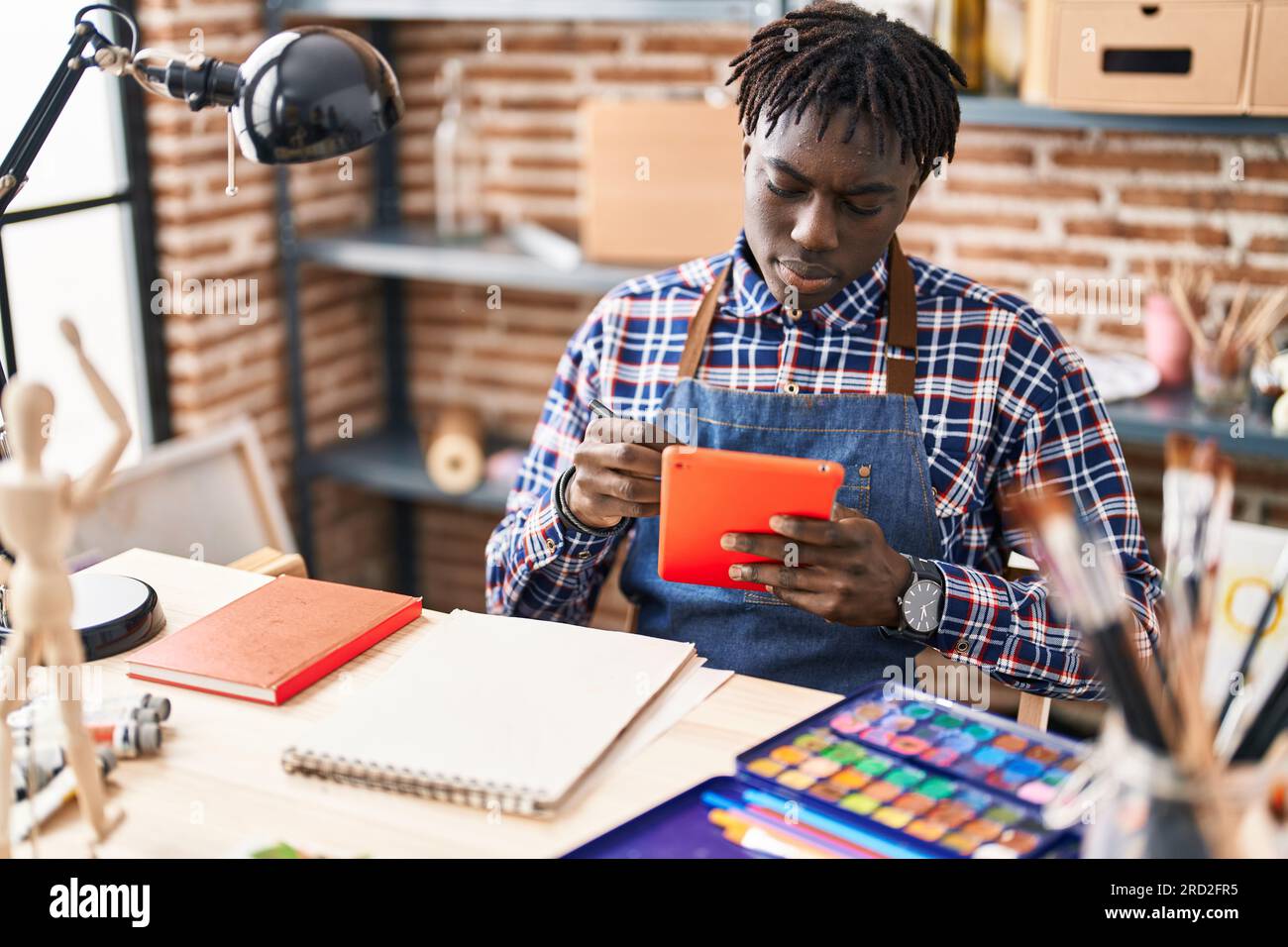 African american man artist drawing on touchpad at art studio Stock ...