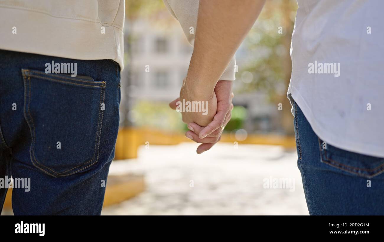 Two men couple standing with hands together at park Stock Photo - Alamy