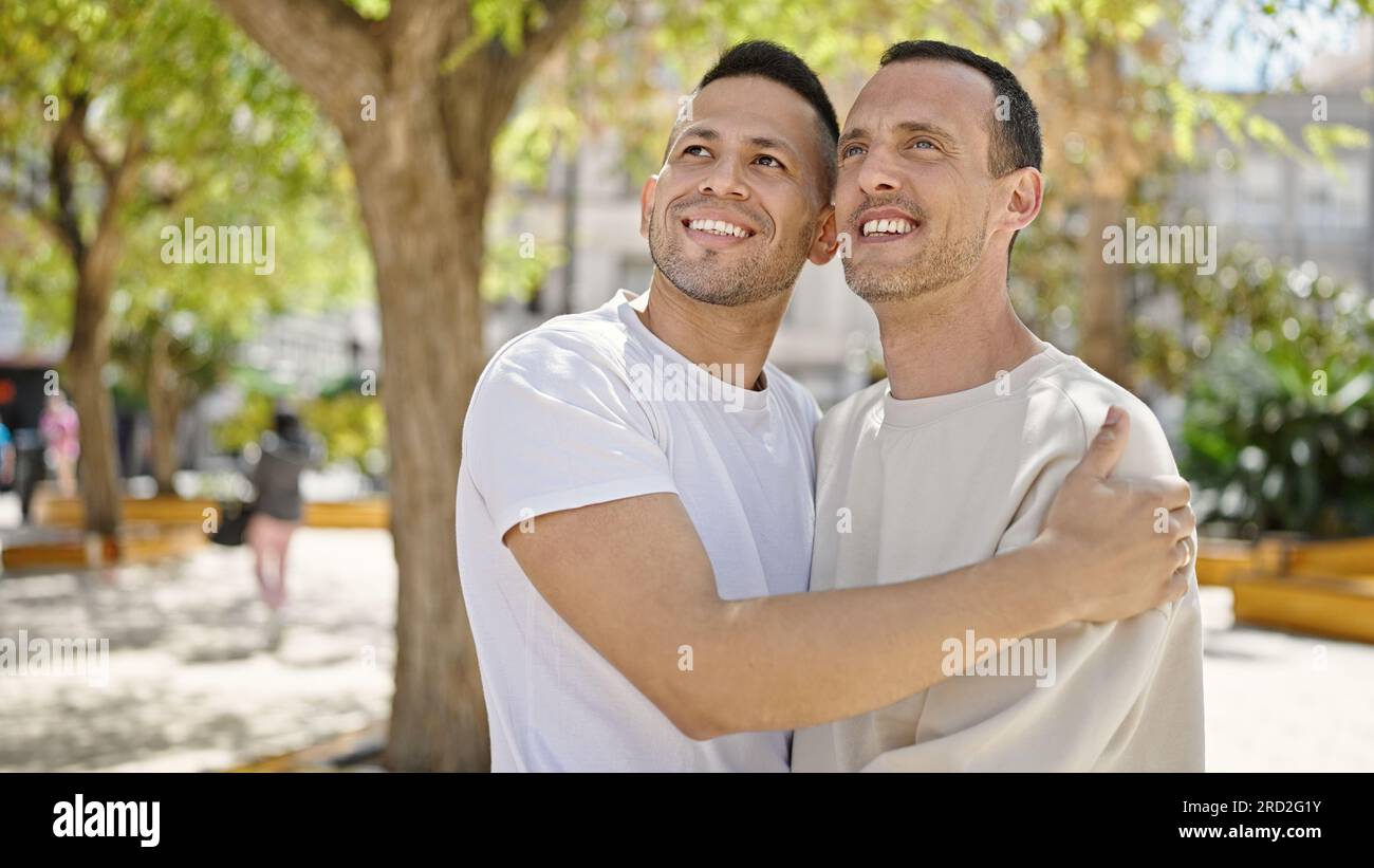 Two men couple smiling confident hugging each other at park Stock Photo ...