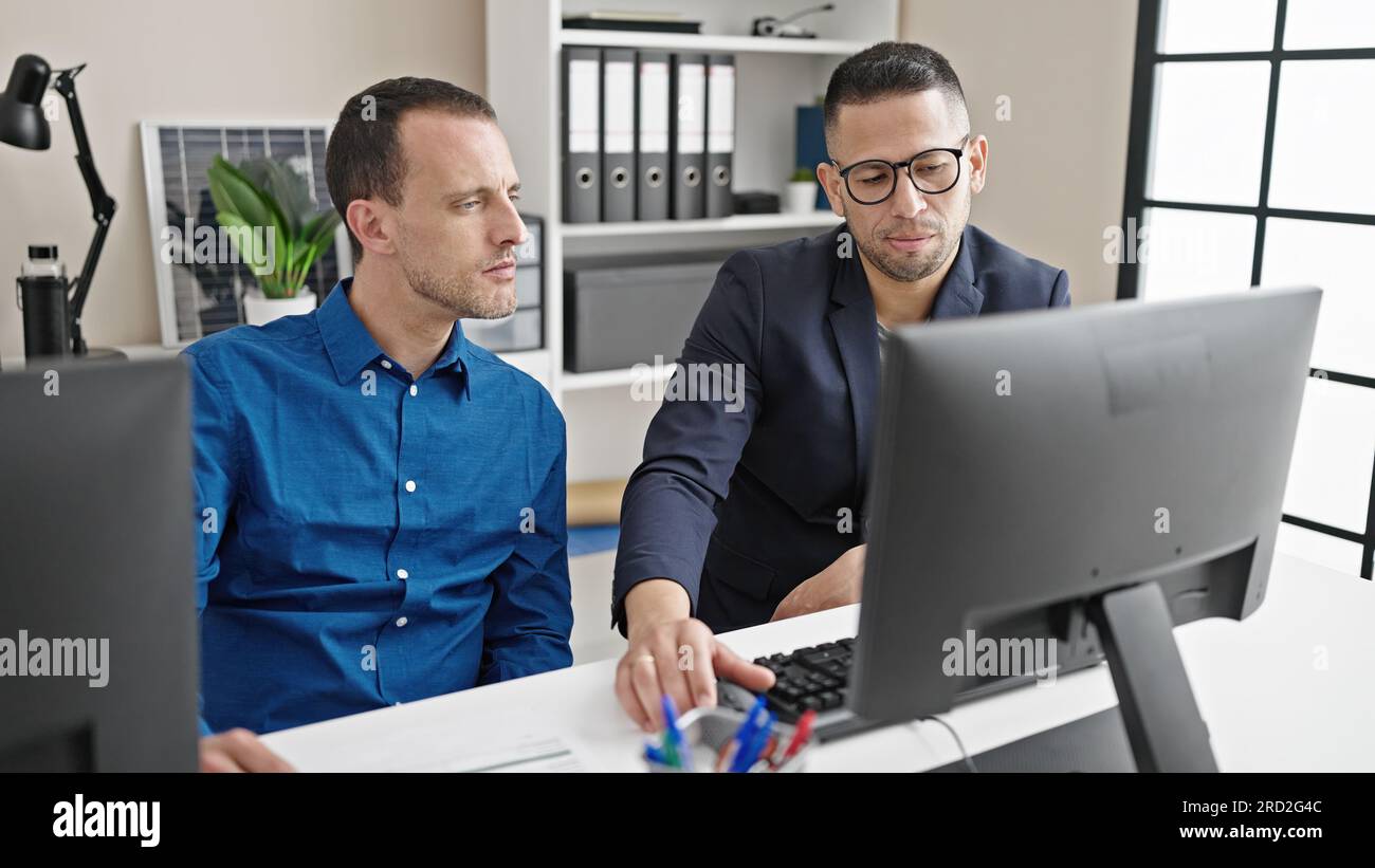 Two men business workers using computer working at office Stock Photo ...